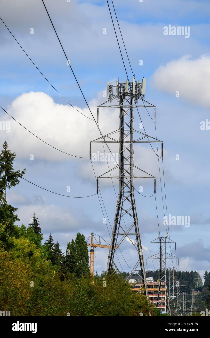 Cellular antennas installed on the top of a power lines tower, sunny ...