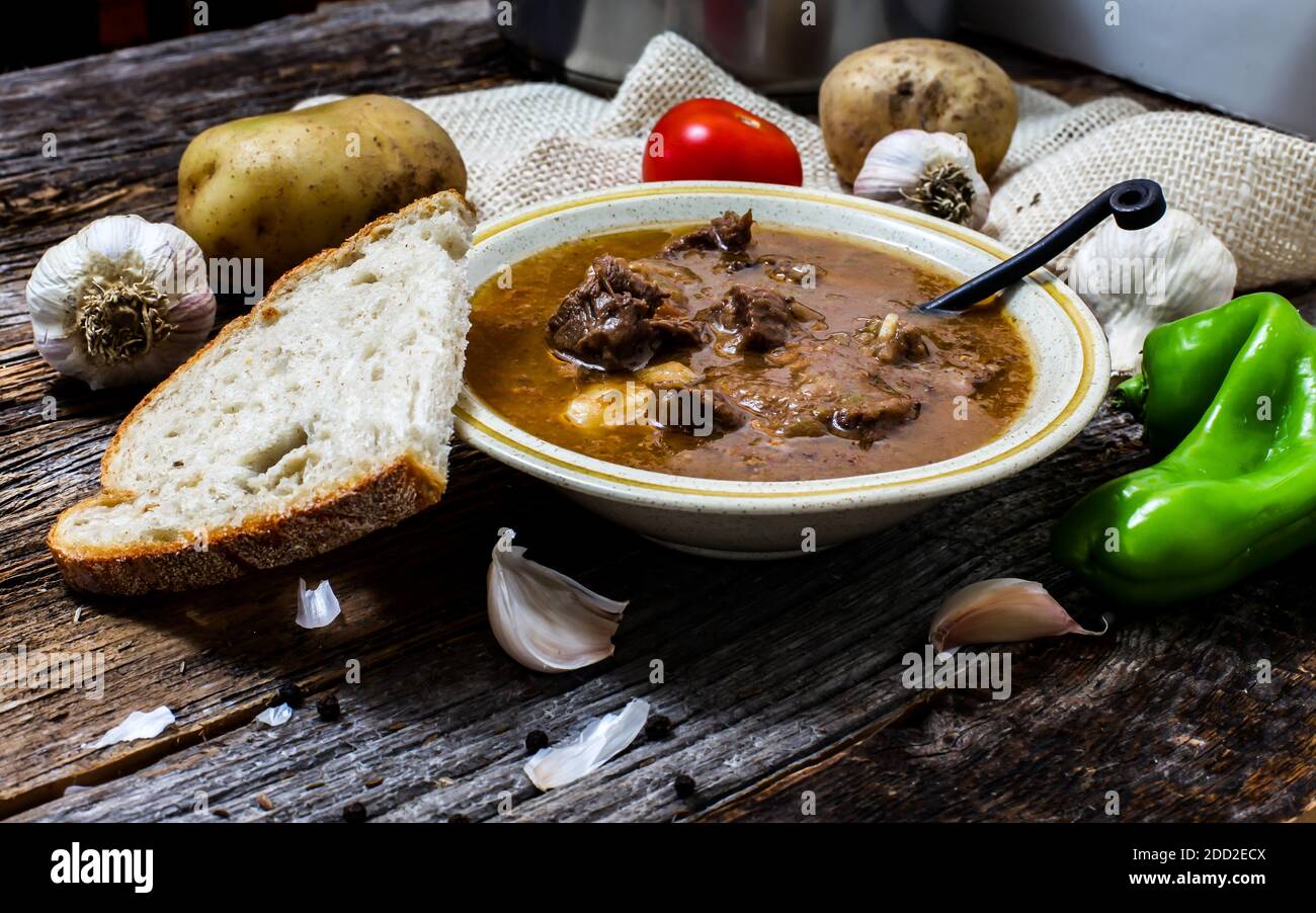 Traditional beef stew on rustic wooden table Stock Photo - Alamy