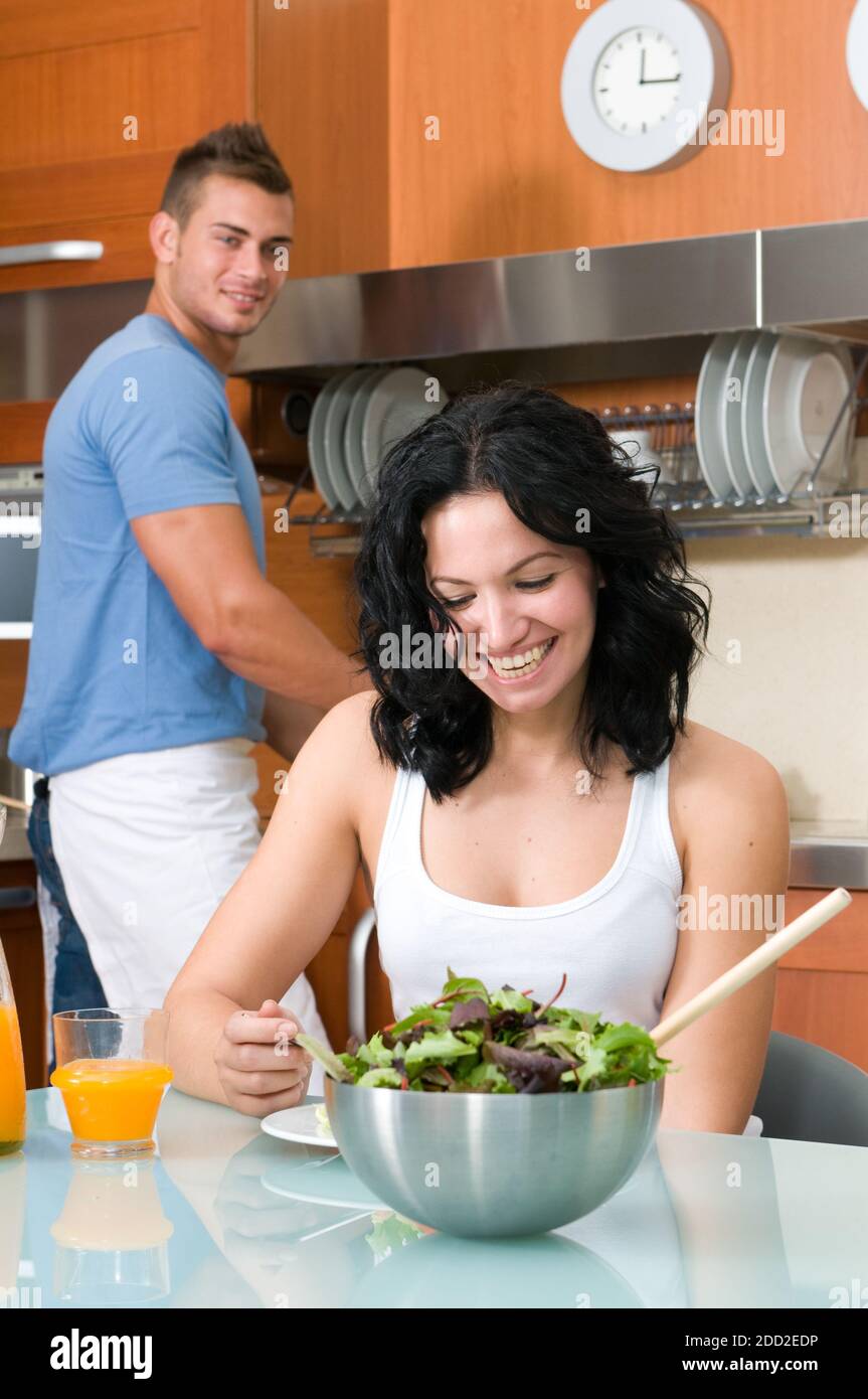 young couple eating healthy in the kitchen Stock Photo - Alamy