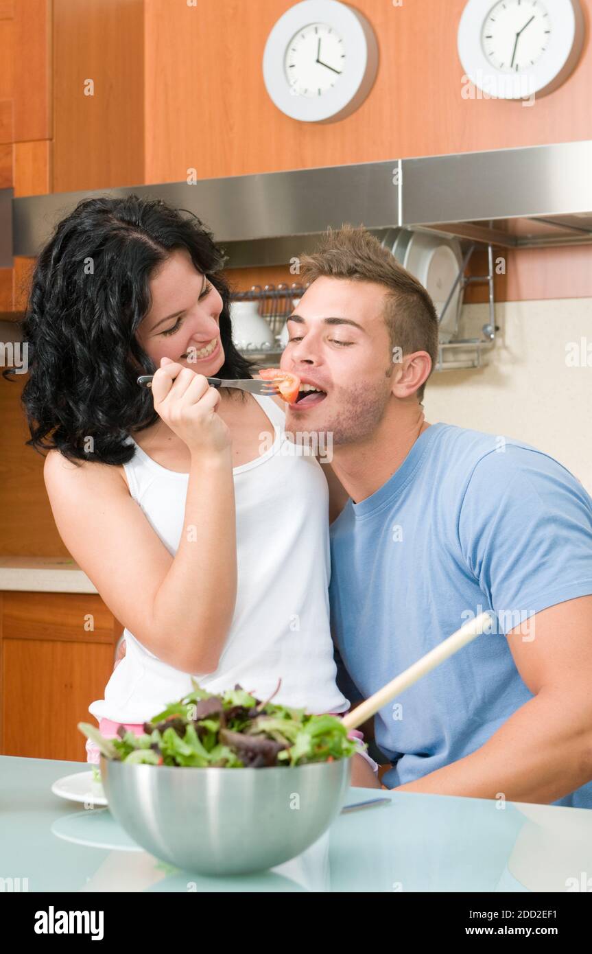 young couple eating healthy in the kitchen Stock Photo - Alamy