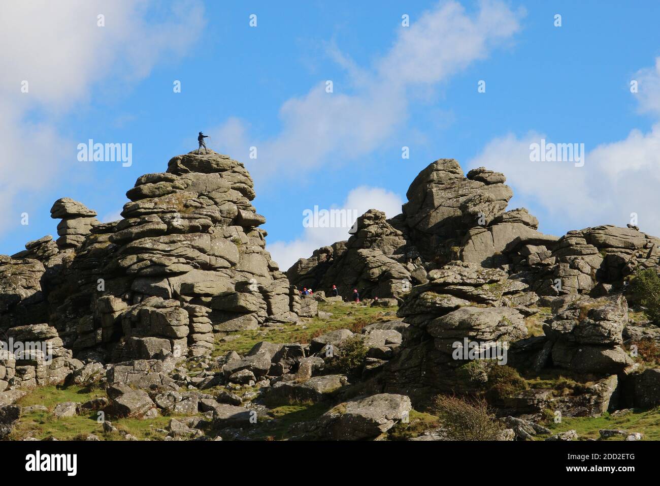Climbers enjoying the challenge of Hound Tor in Dartmoor National Park ...