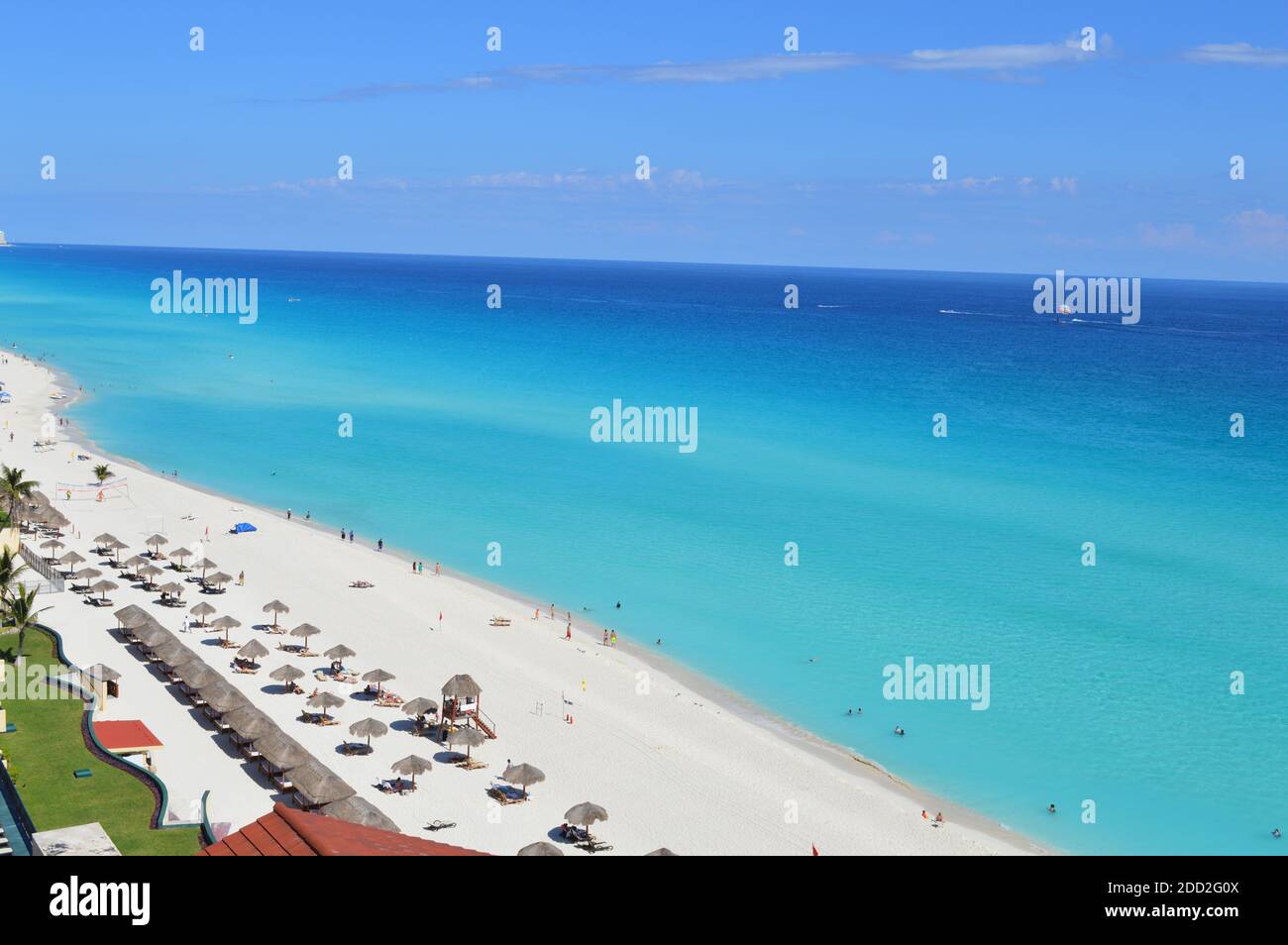 An aerial view of white sand beach and blue water at Cancun, Mexico ...
