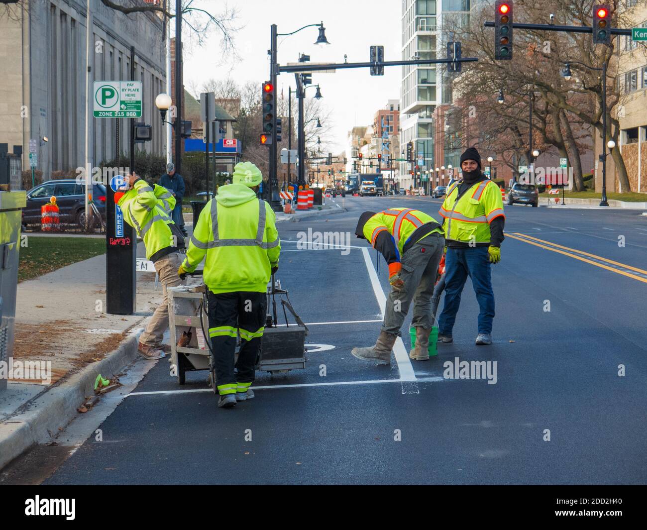Pavement painting crew painting wheelchair icon in handicapped parking ...