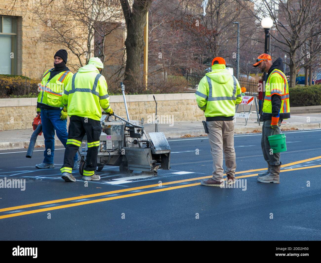 Pavement painting crew laying down traffic controll marking in left ...