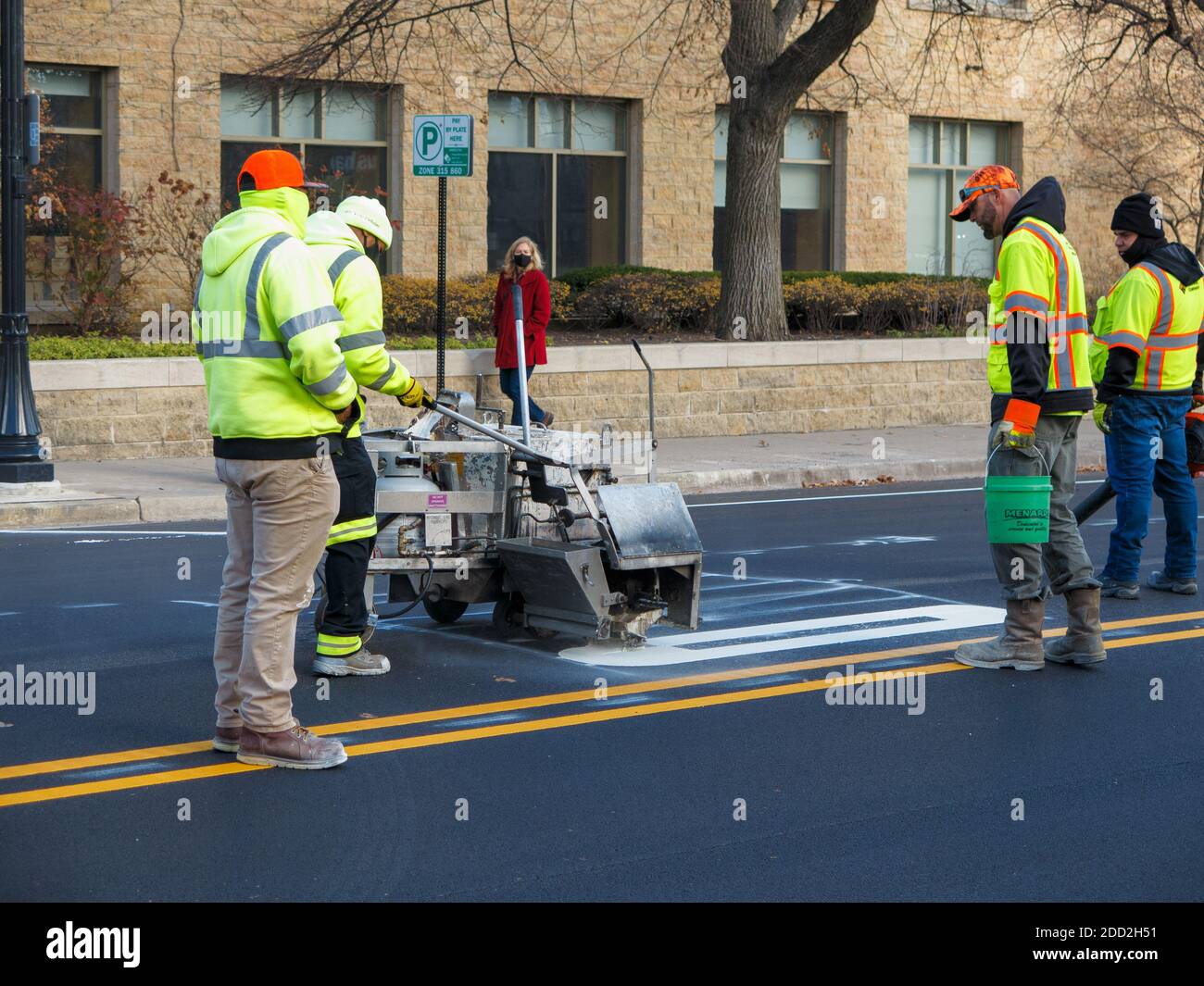 Pavement painting crew laying down traffic controll marking in left ...