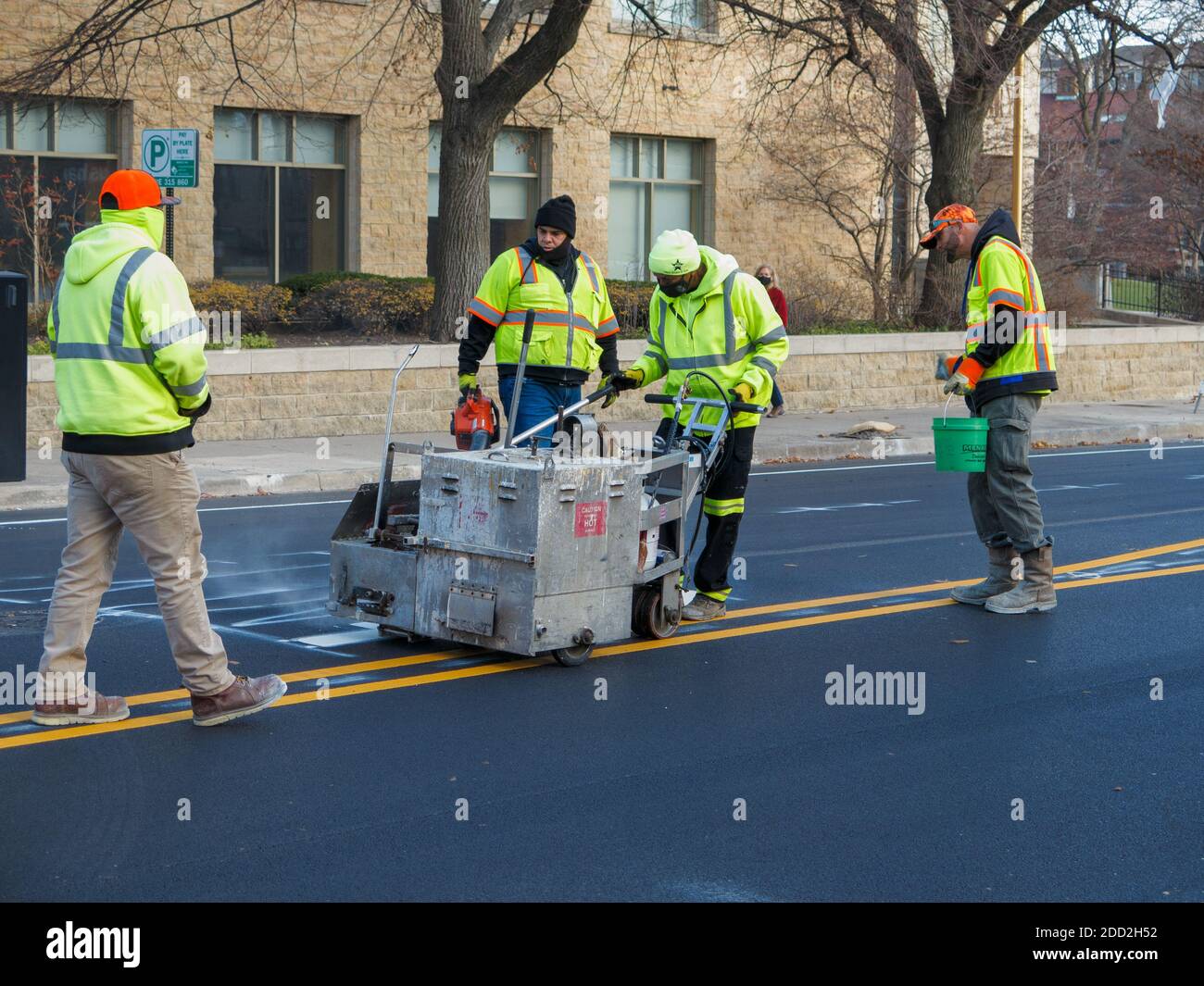 Pavement painting crew laying down traffic controll marking in left ...