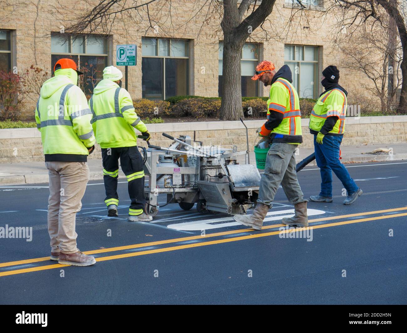 Pavement painting crew laying down traffic controll marking in left ...