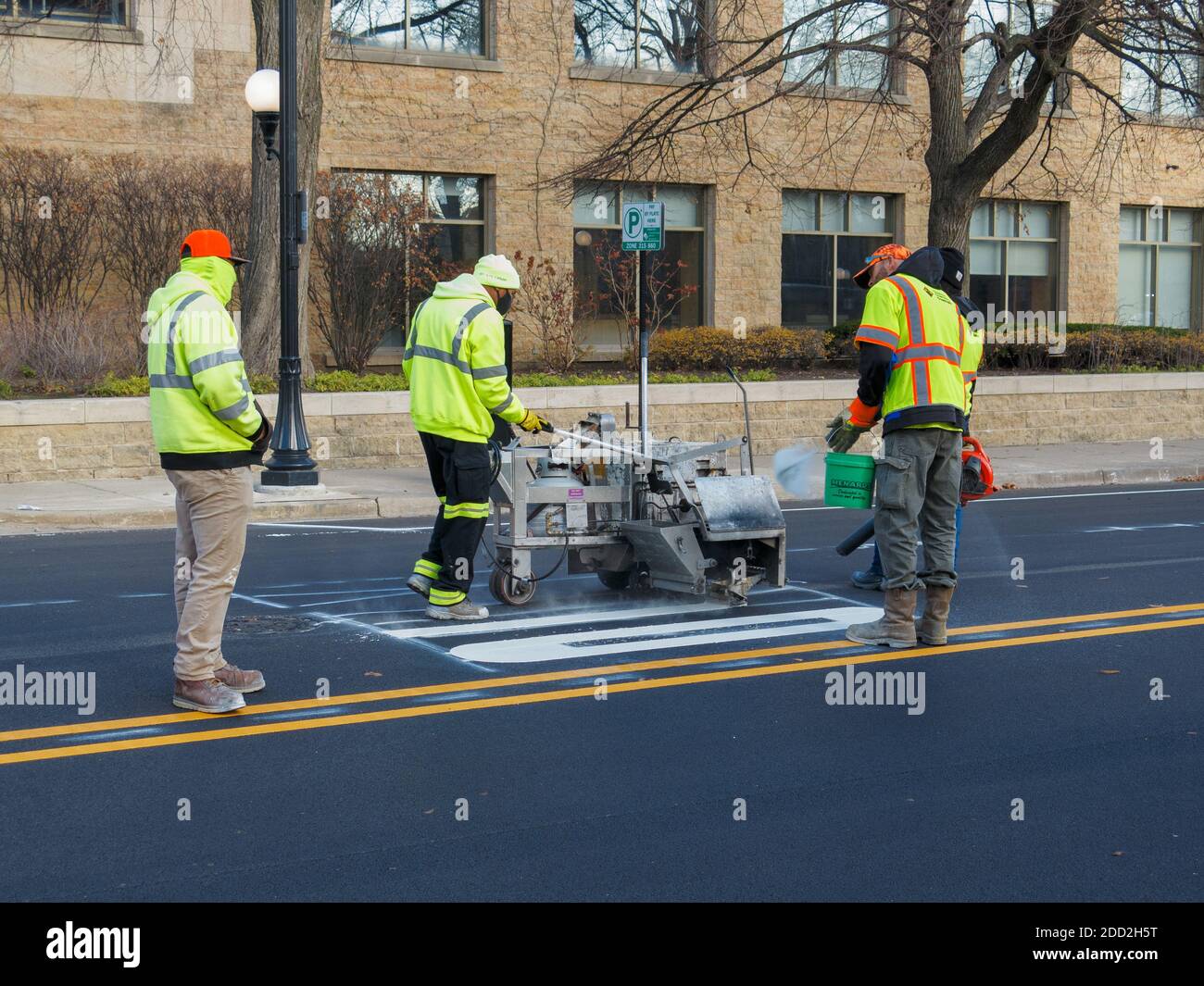 Pavement painting crew laying down traffic controll marking in left ...