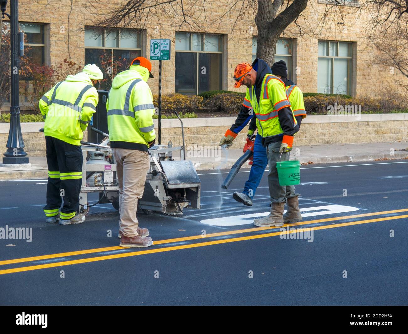 Pavement painting crew laying down traffic controll marking in left ...