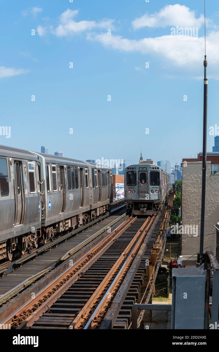 Elevated train track and L train cars with downtown Chicago in the ...