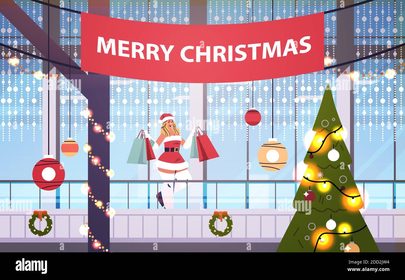 santa woman with gifts walking in shopping mall decorated for merry ...
