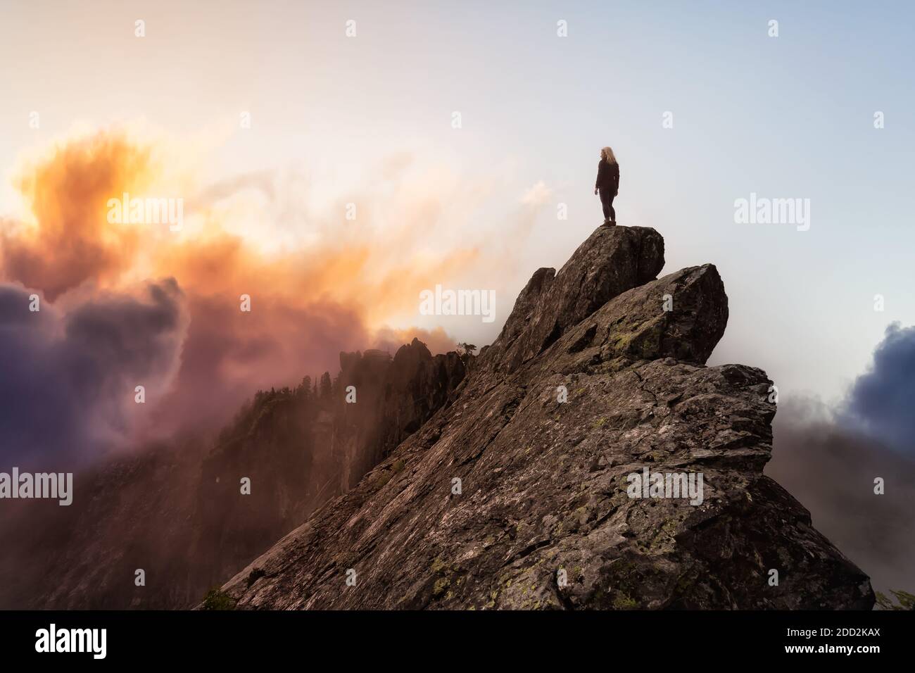 Adventurous Girl on top of a Mountain Peak Stock Photo - Alamy