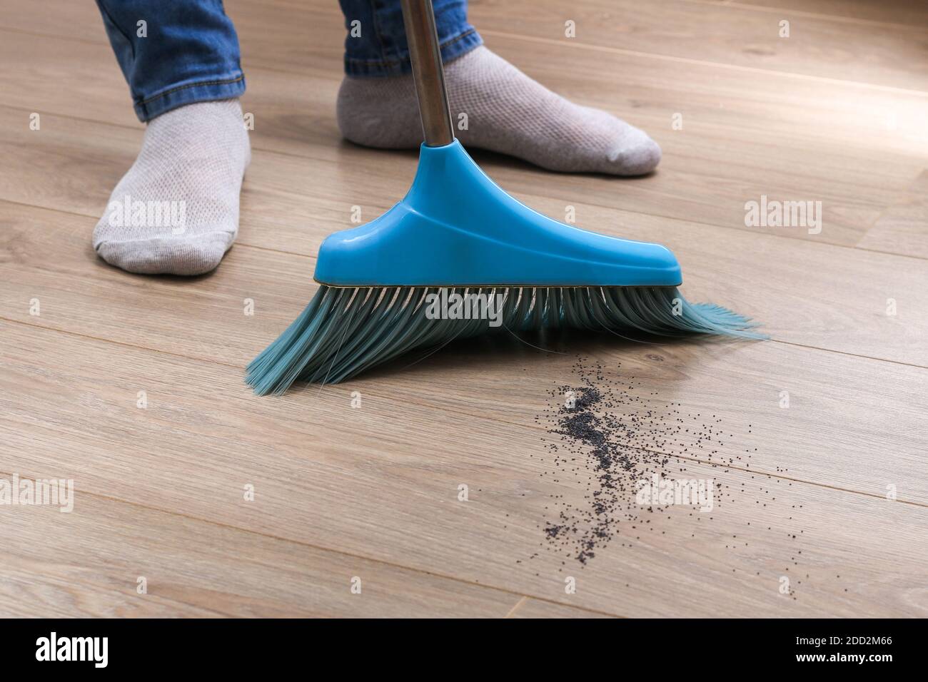 Man sweeping floor dustpan broom hi-res stock photography and images ...