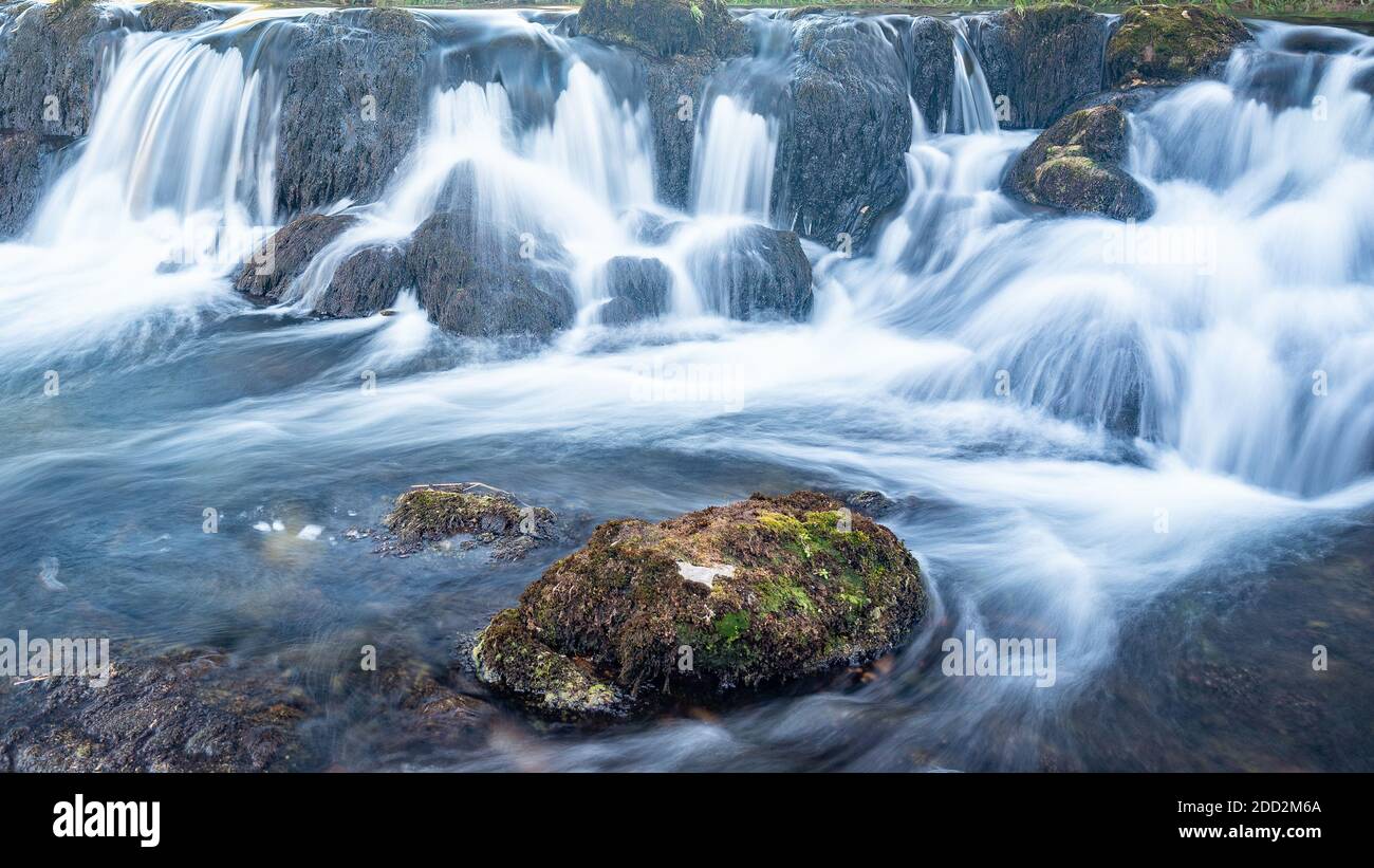 A beautiful shot of small waterfalls in the forest Stock Photo - Alamy