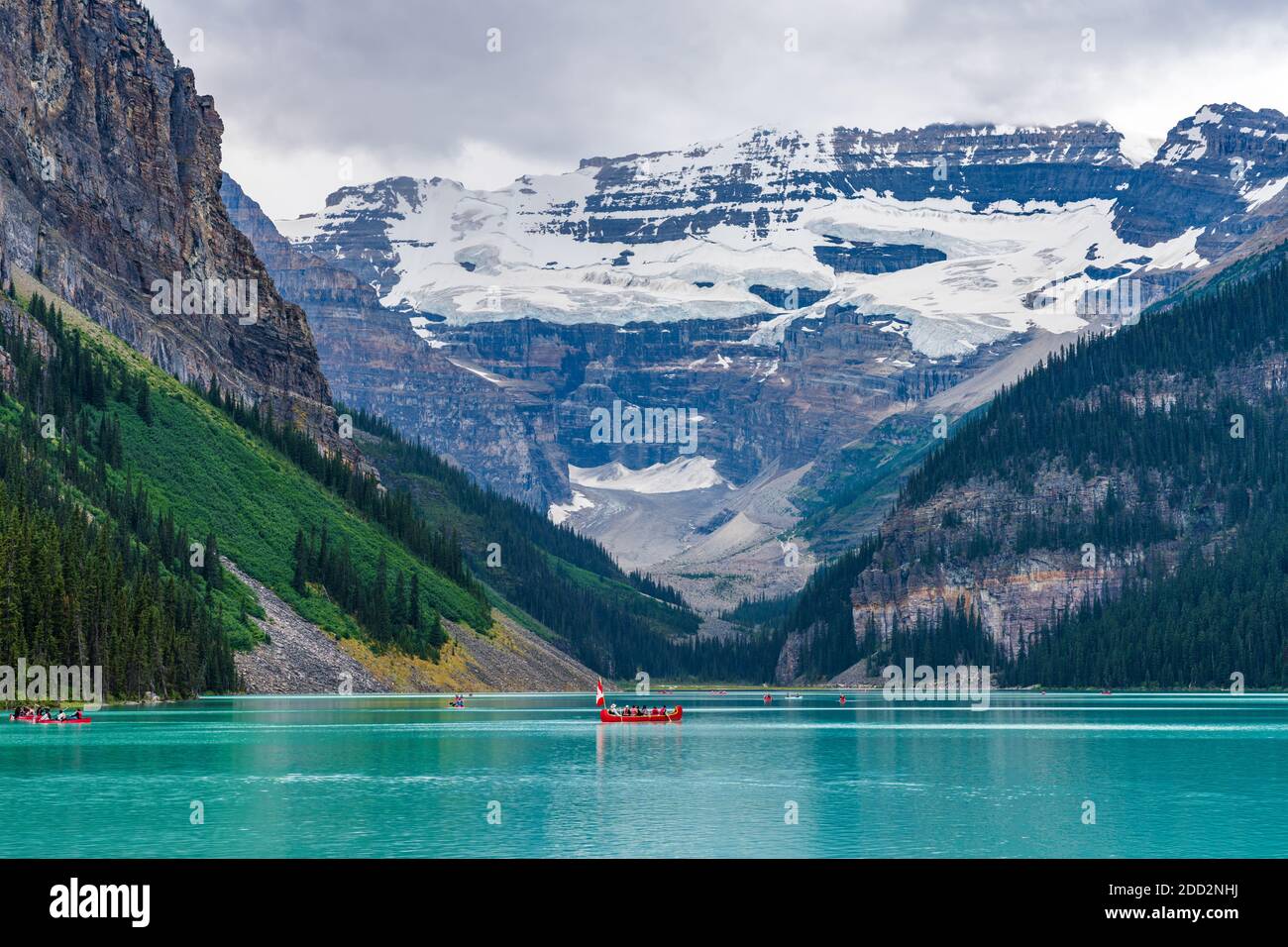 Canoeing on Lake Louise in summer day. Tourists enjoy leisure water ...