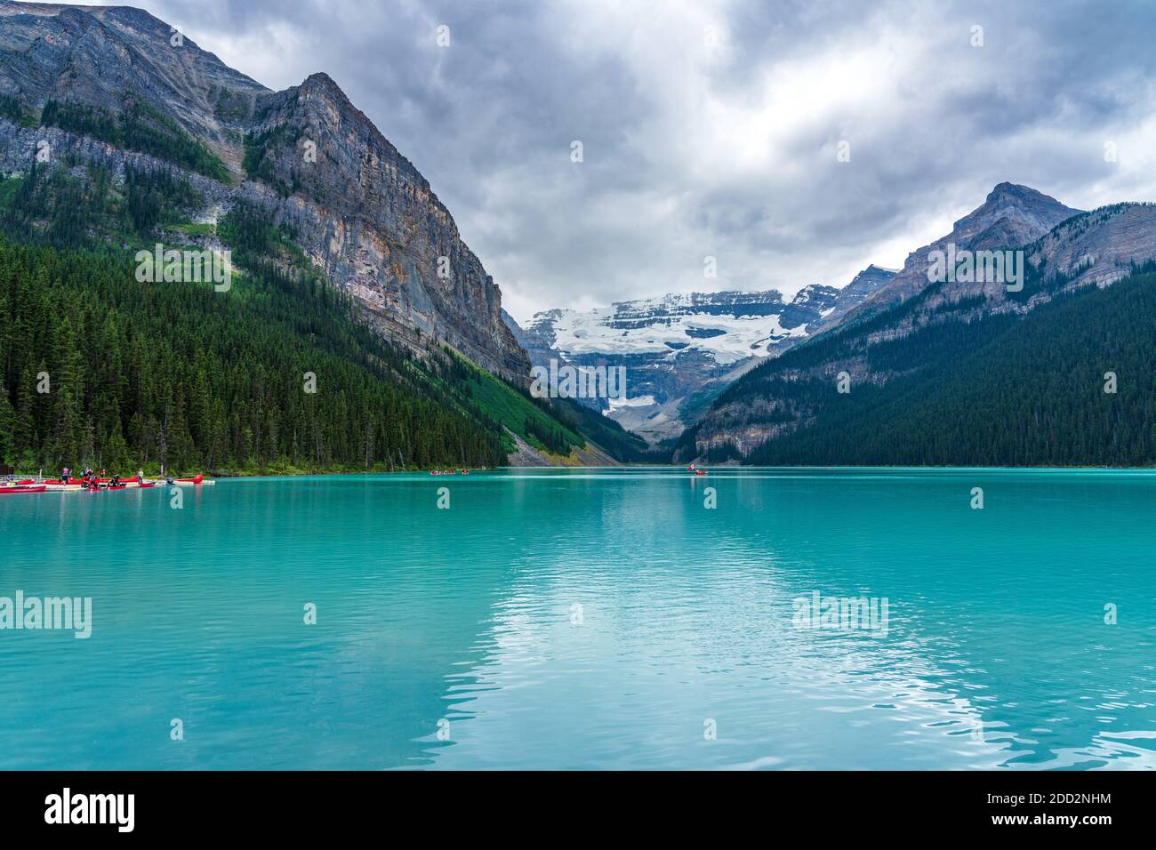 Canoeing on Lake Louise in summer day. Tourists enjoy leisure water ...