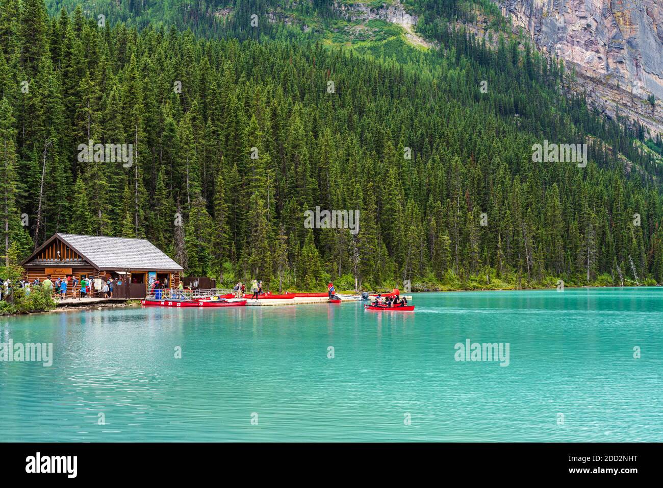 Canoeing on Lake Louise in summer day. Tourists enjoy leisure water ...