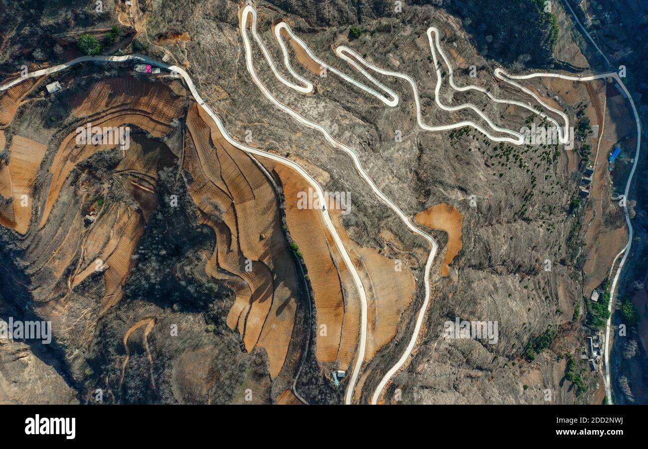 The western mountains of narrow road and crescent field Stock Photo - Alamy