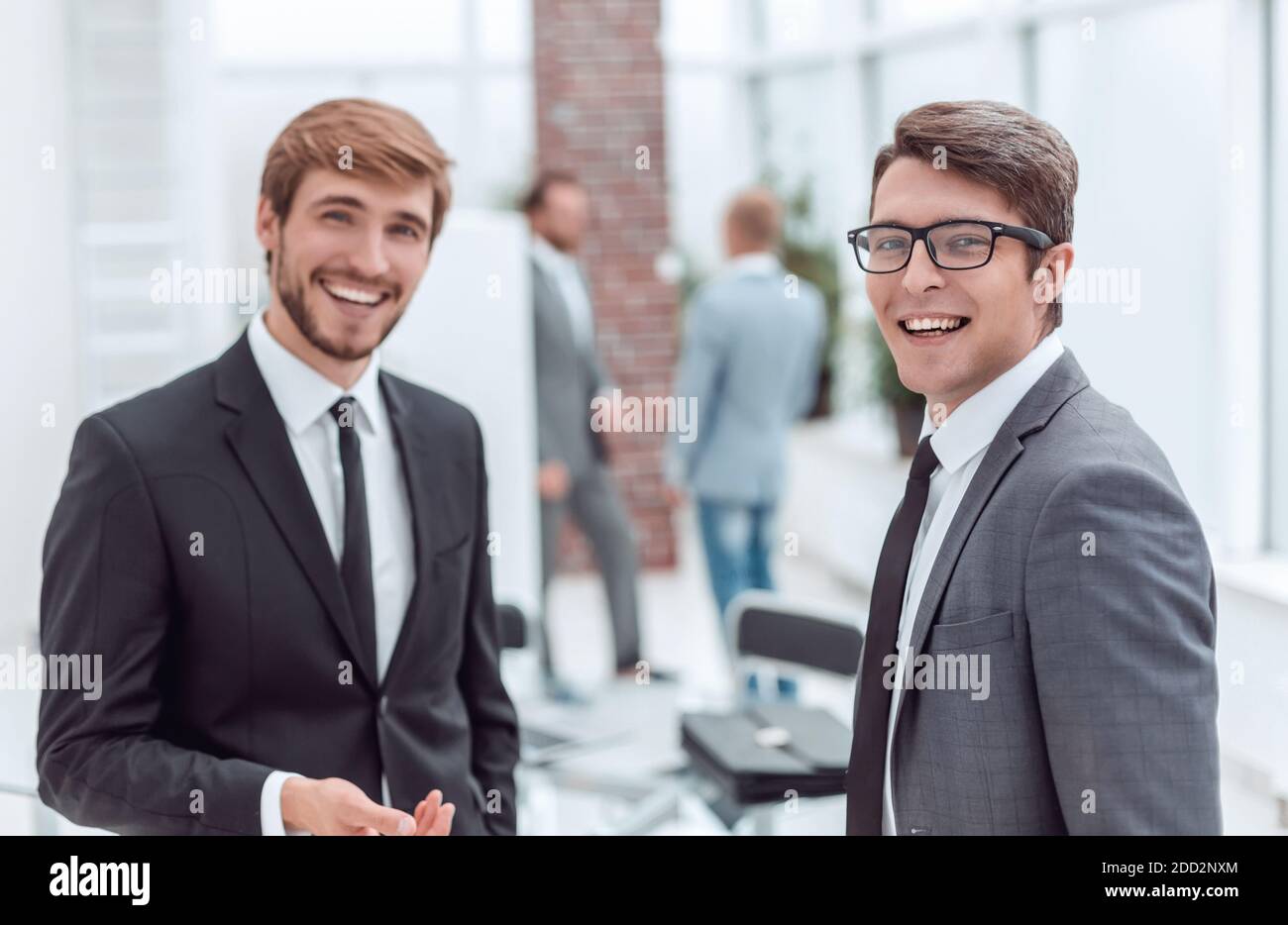 Employees discuss ideas standing hi-res stock photography and images ...