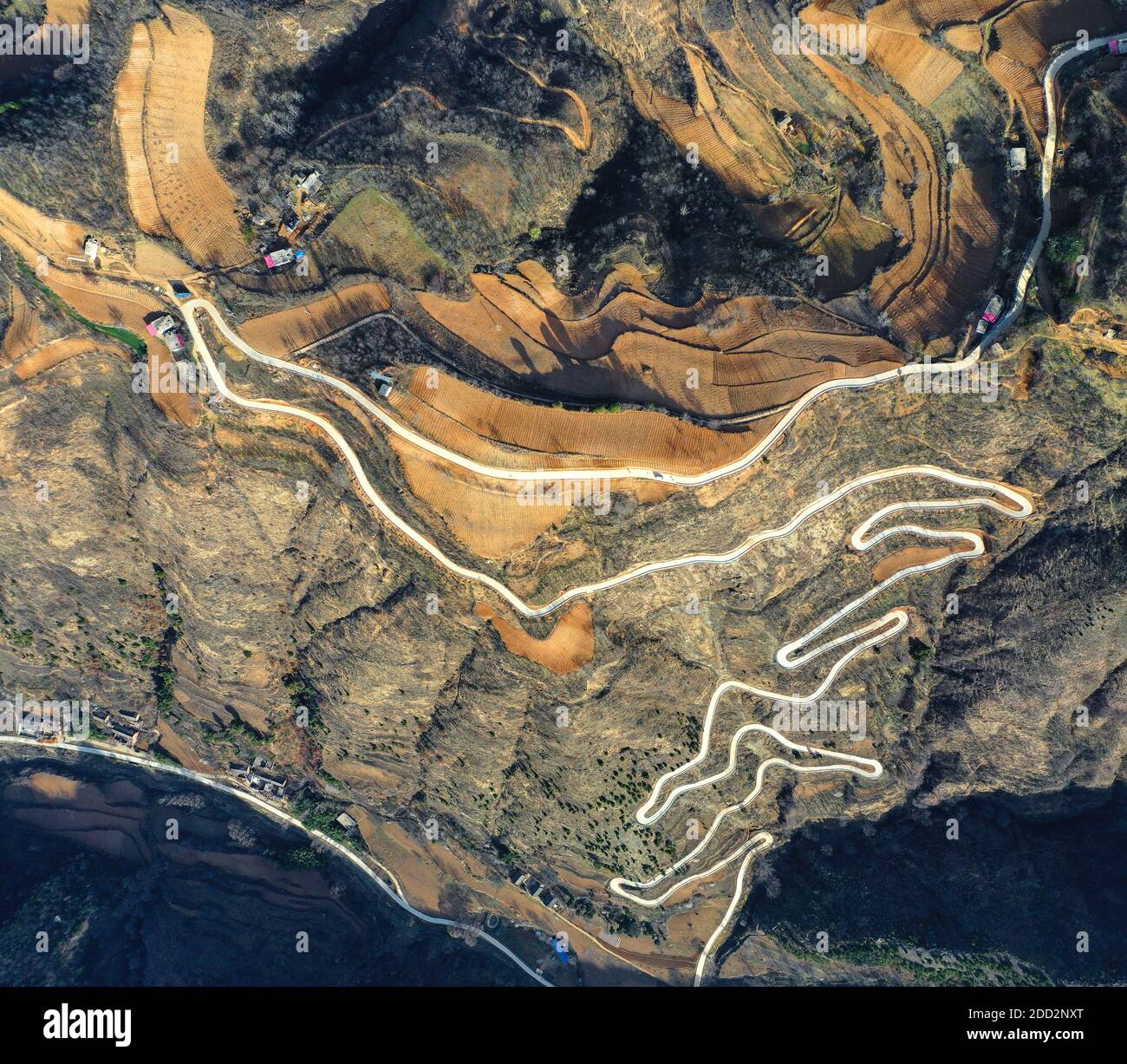 The western mountains of narrow road and crescent field Stock Photo - Alamy