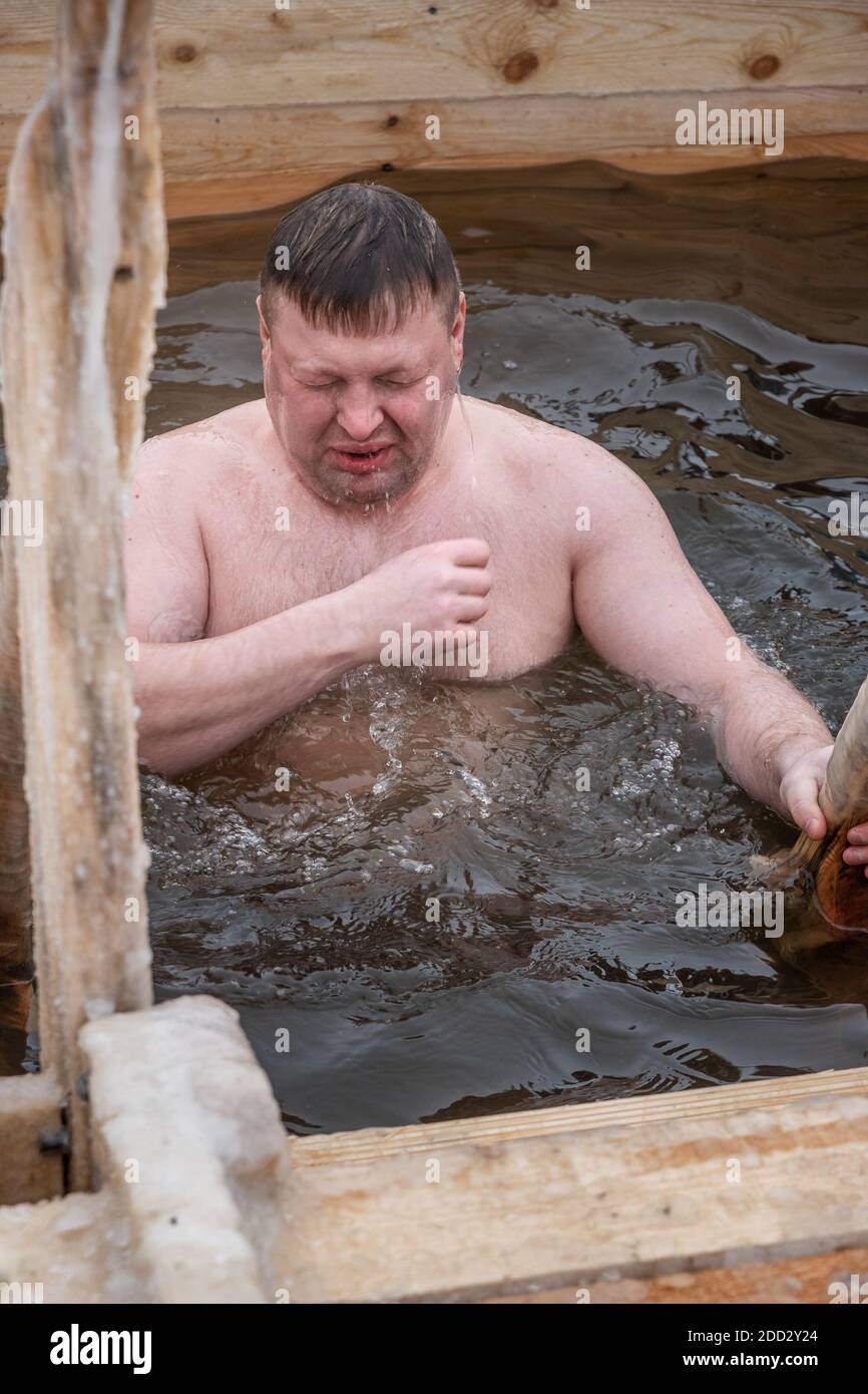 Nizhny Tagil, Russia - January 19, 2020: Man bathes into cold water of ...