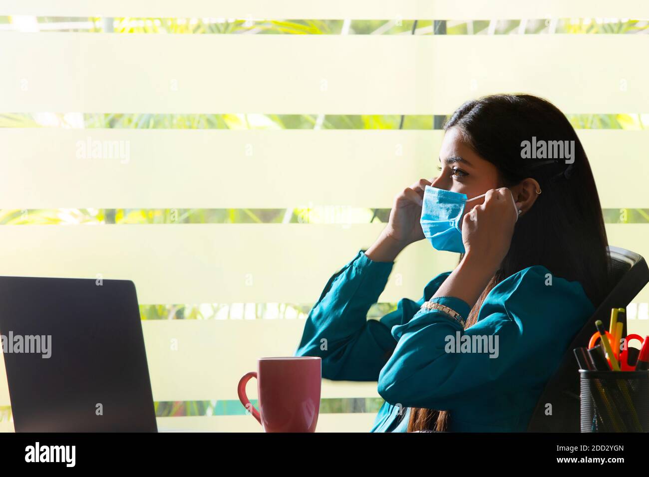 Person in office wearing mask hi-res stock photography and images - Alamy