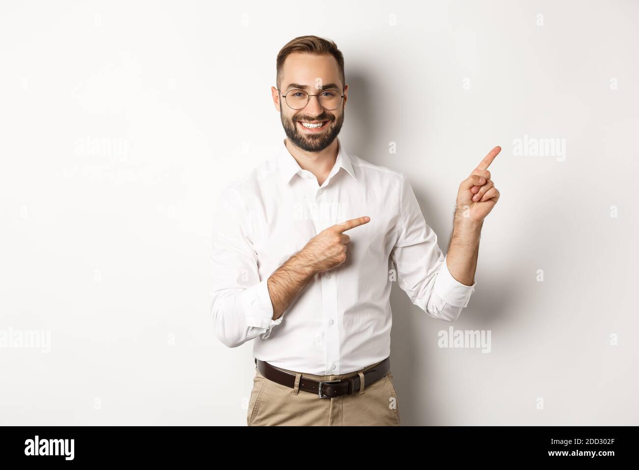 Handsome successful businessman pointing fingers right, showing ...