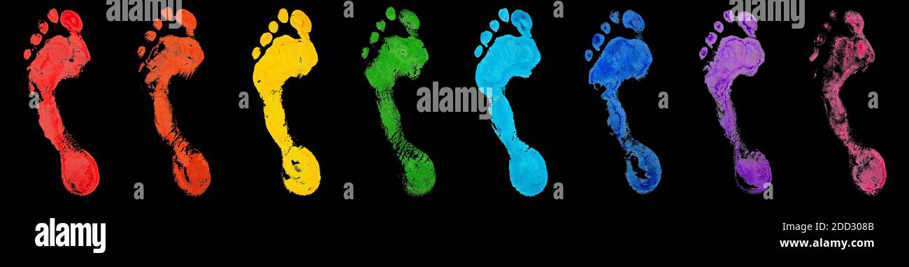 Rainbow color human footprints set black background isolated close up ...