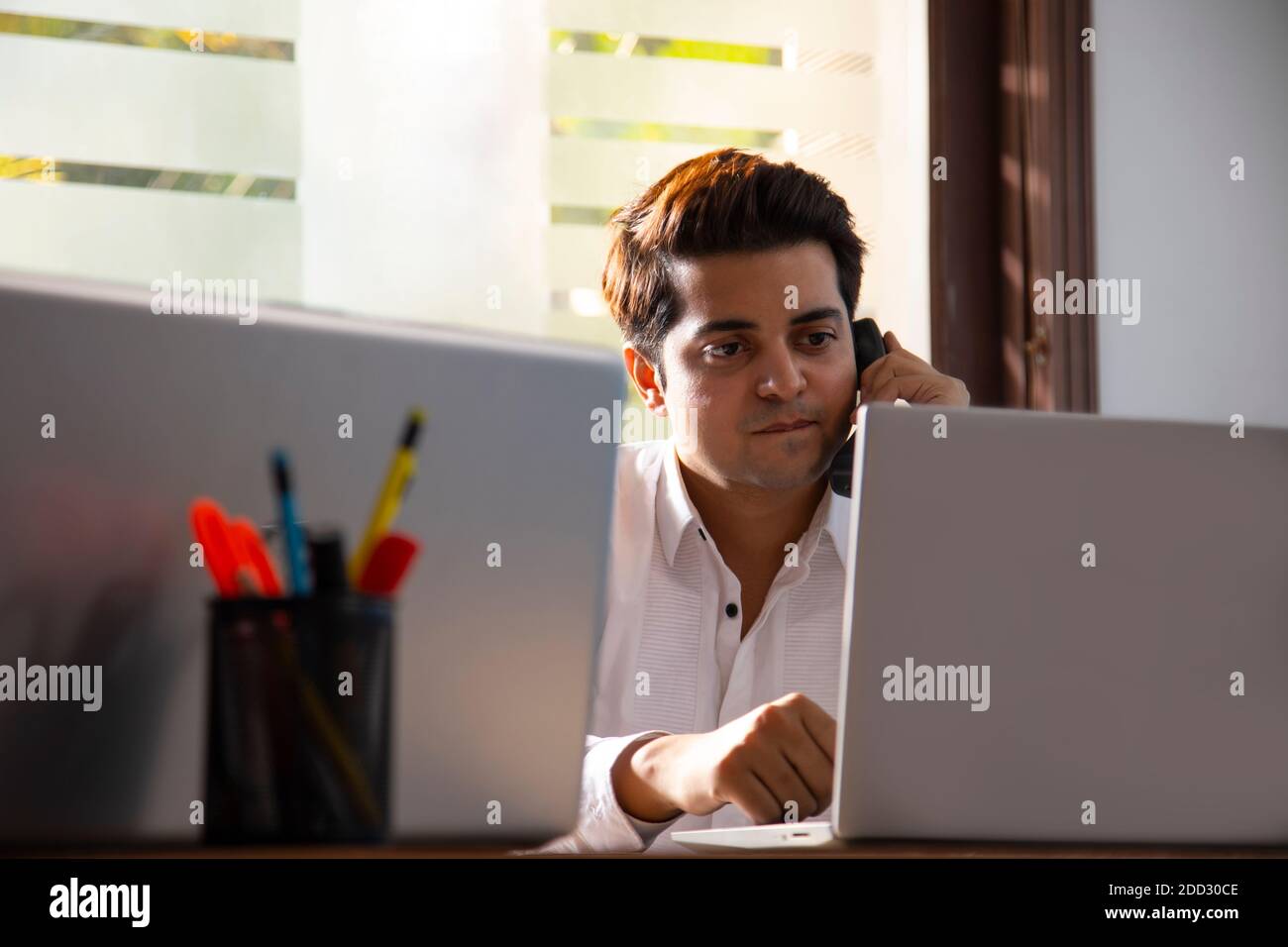 AN OFFICE EXECUTIVE TALKING TO CLIENT OVER TELEPHONE Stock Photo - Alamy