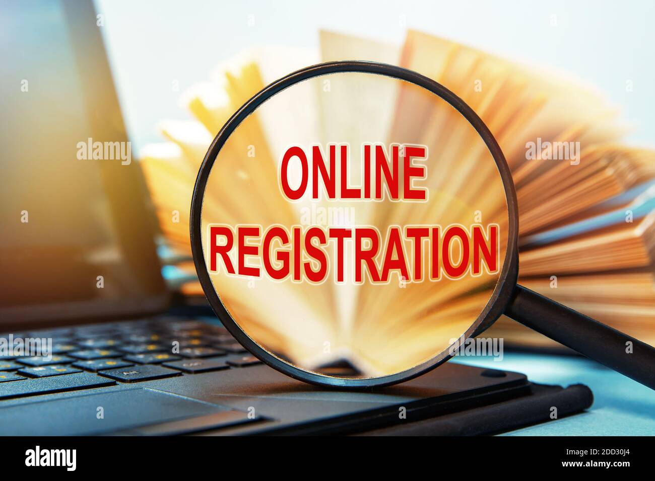 Laptop computer and book with a magnifying glass. Text ONLINE ...