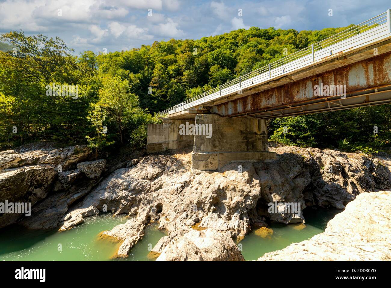 Metal bridge over a river in the mountains view from under the bridge ...