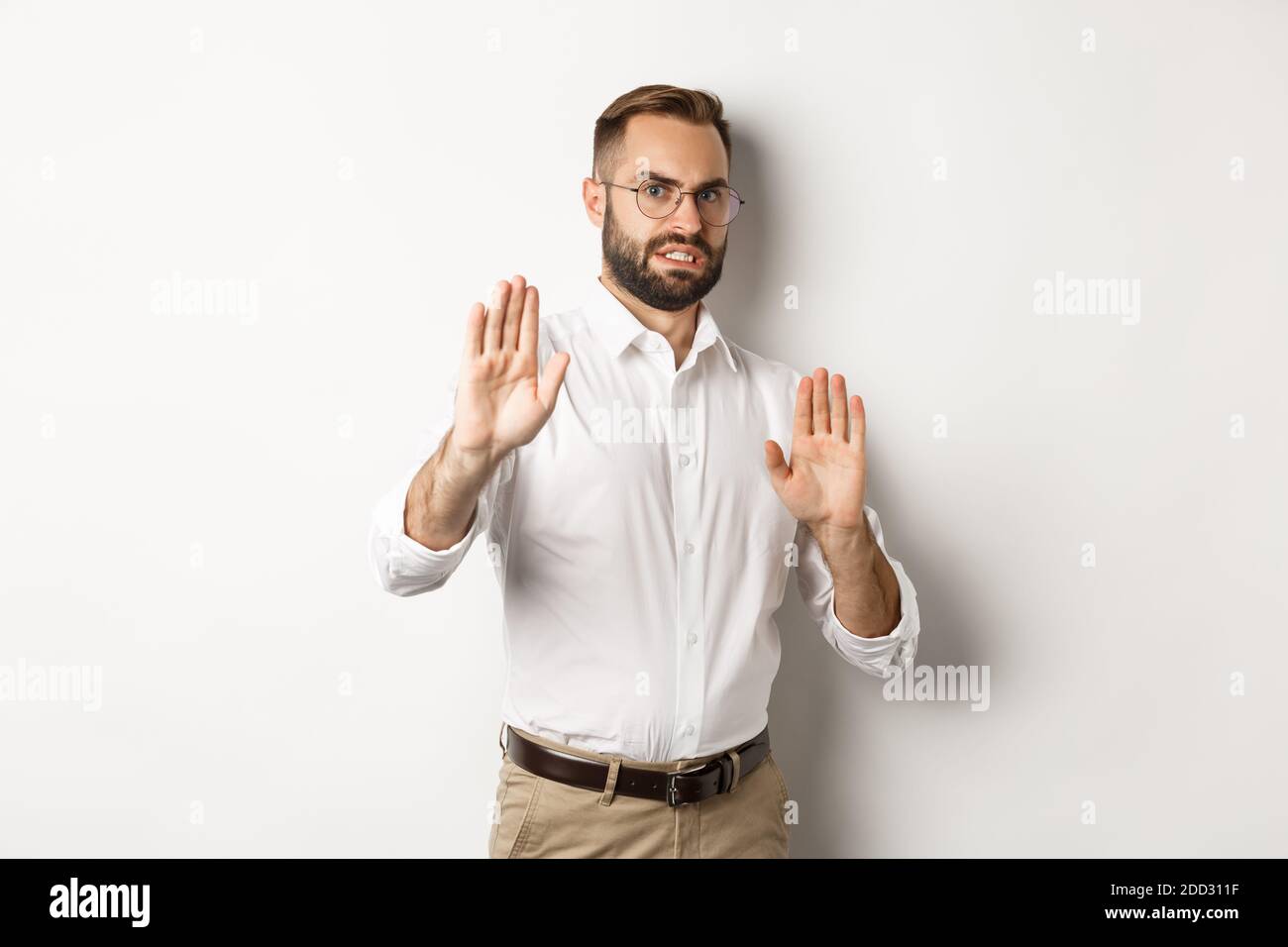 Displeased man rejecting something disturbing, showing stop sign and ...