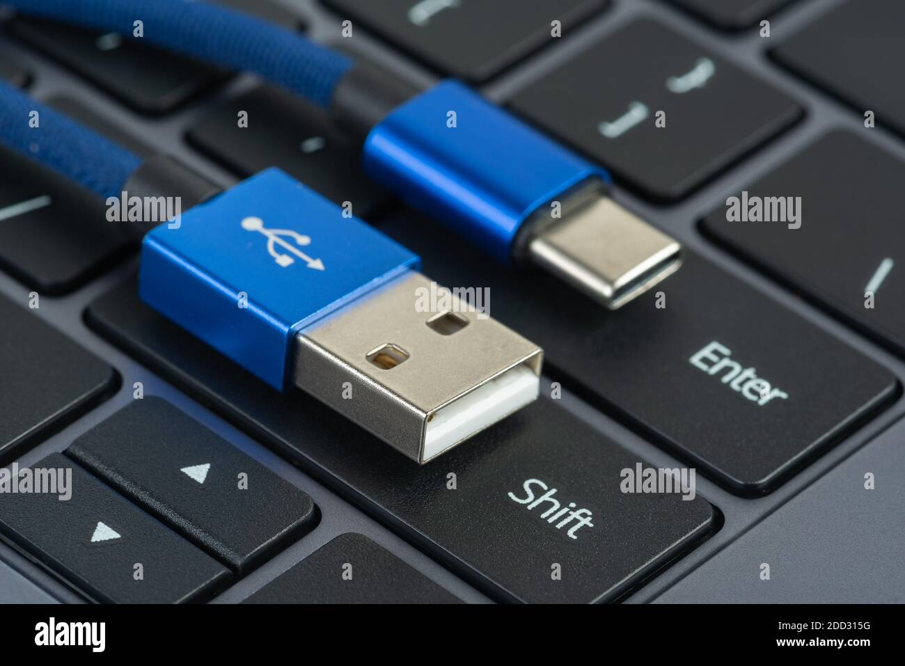 Usb cable on buttons of laptop keyboard Stock Photo - Alamy