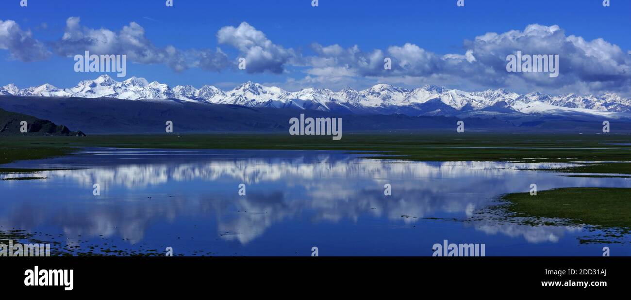 Reflections on the brook snow mountain Stock Photo - Alamy