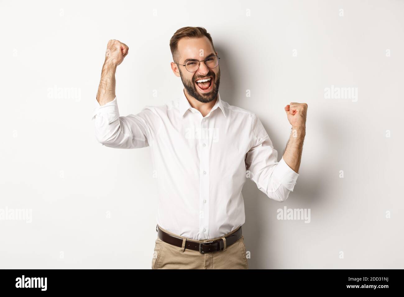Successful businessman rejoicing, raising hands up and celebrating ...
