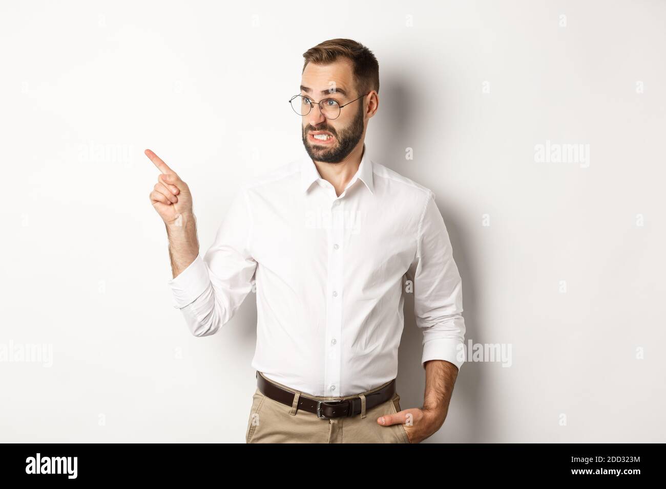 Young bearded guy seeing something disturbing, cringe while pointing ...