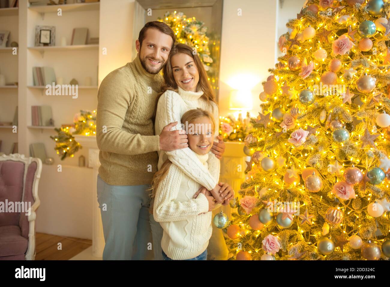 Cute family celebrating christmas and feeling wonderful Stock Photo - Alamy