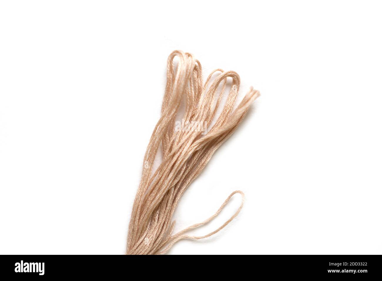 Tangled beige thread on white background isolated Stock Photo - Alamy