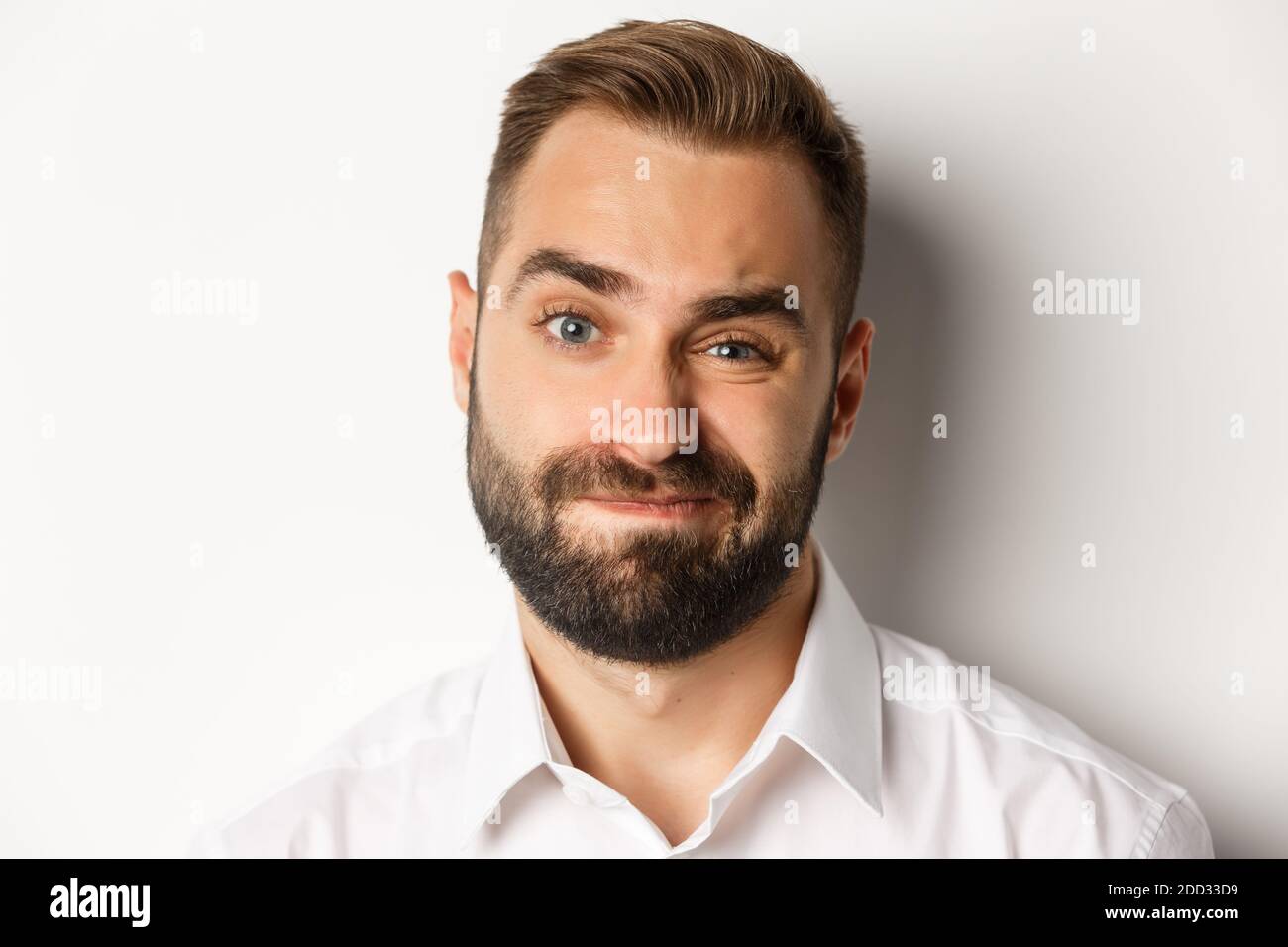 Emotions and people concept. Headshot of skeptical man with beard ...