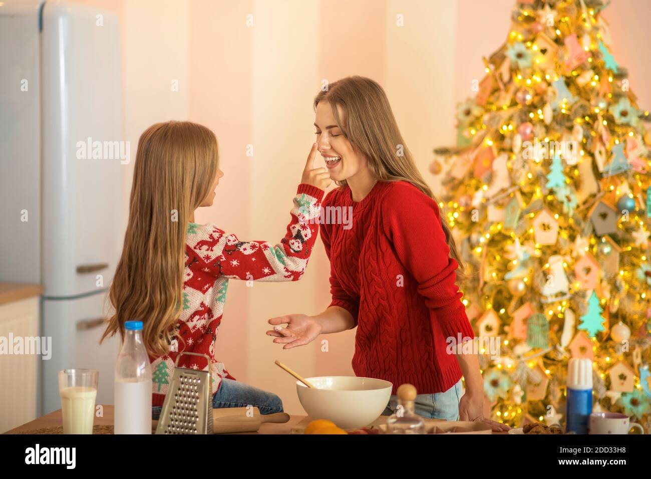 Mom and daughter cooking together in the kitchen and having fun Stock ...