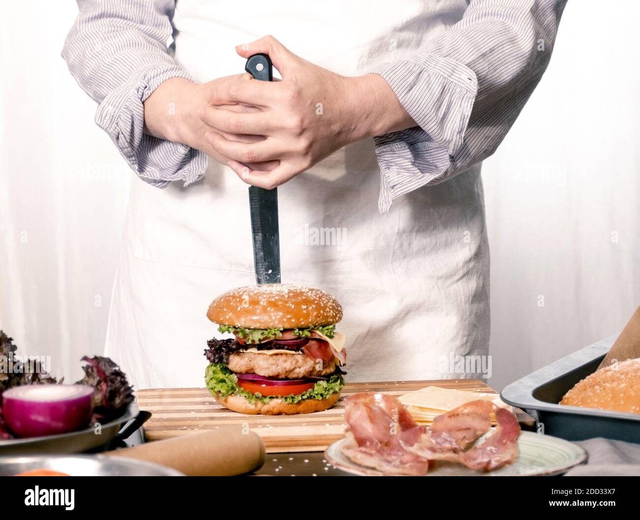 Female Chif cooking Big Burger or Cheeseburger Stock Photo - Alamy