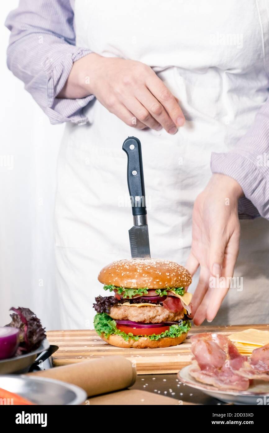 Female Chif cooking Big Burger or Cheeseburger Stock Photo - Alamy