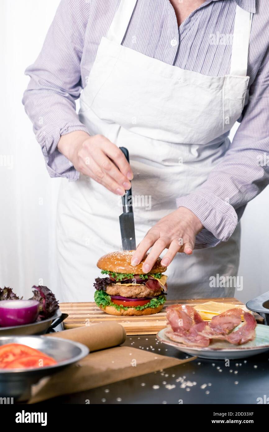 Female Chif cooking Big Burger or Cheeseburger Stock Photo - Alamy