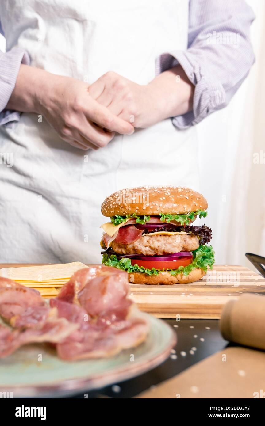 Female Chif cooking Big Burger or Cheeseburger Stock Photo - Alamy