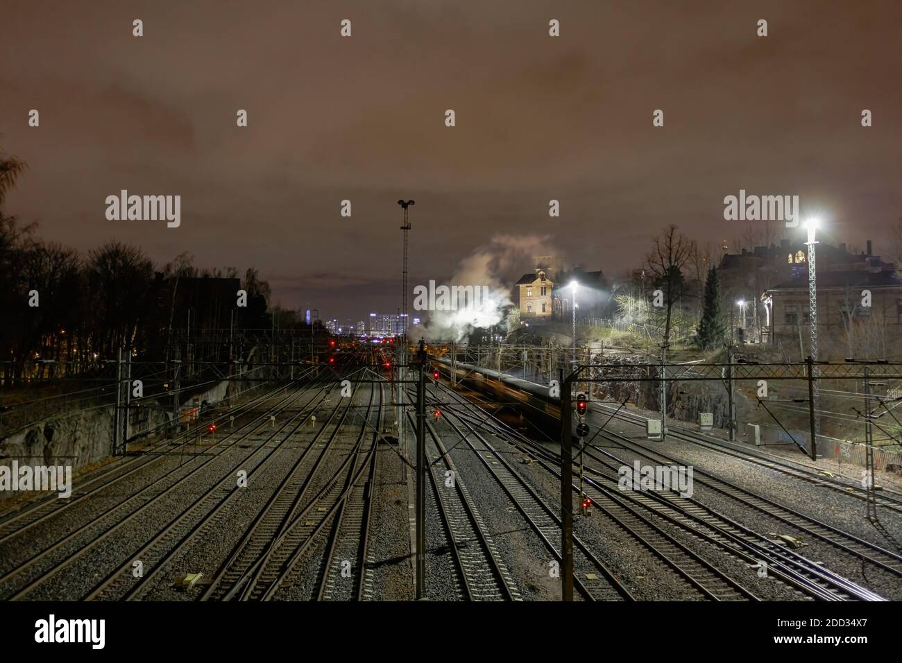Night photo of an old steam locomotive walking along the railroad ...