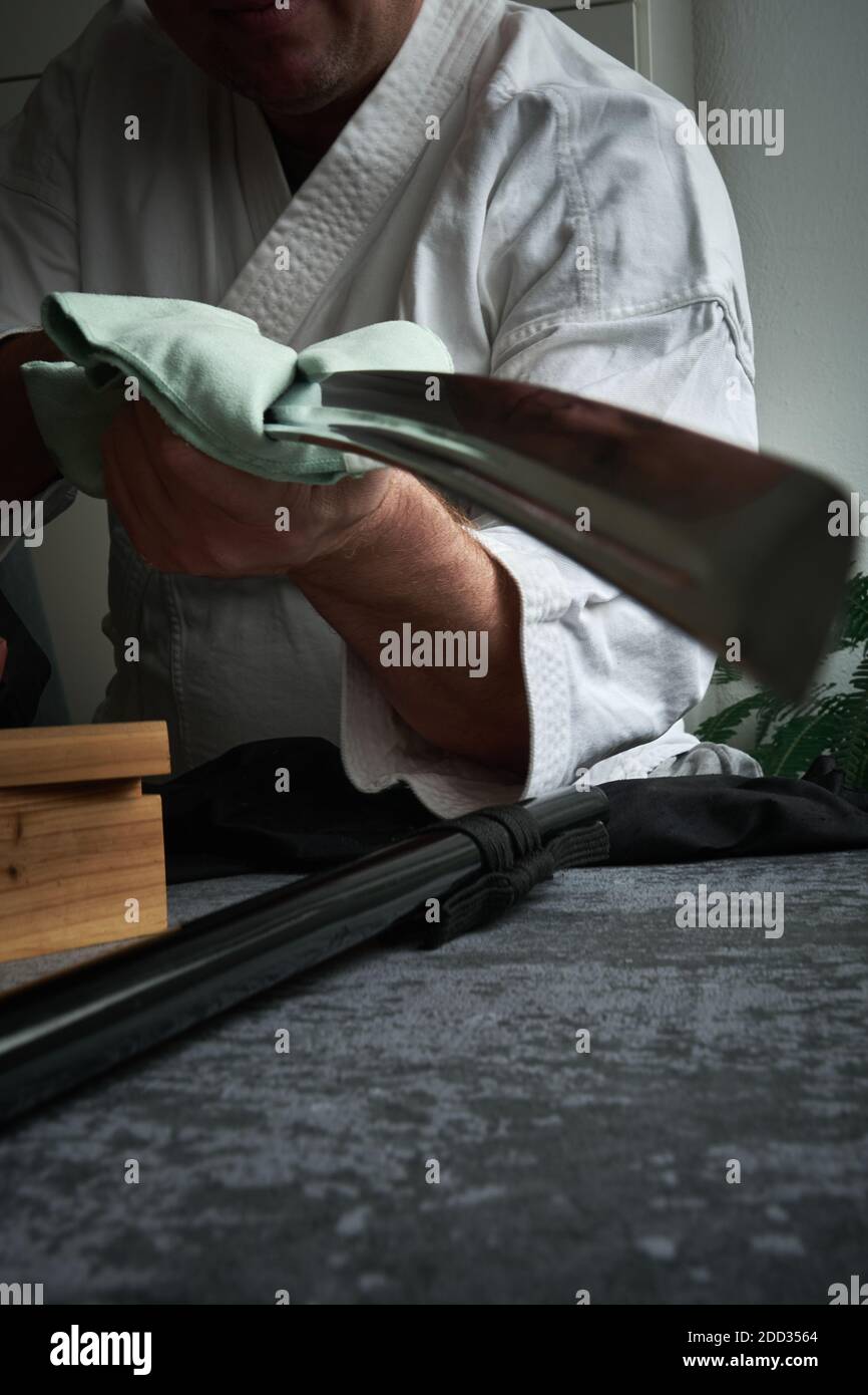 Man cleans blade of traditional Japanese katana sword Stock Photo - Alamy