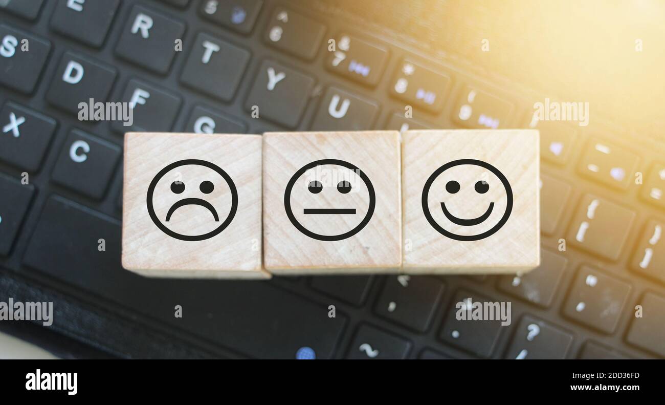 Smiley review. Frown, neutral and happy face on wood blocks toys on ...