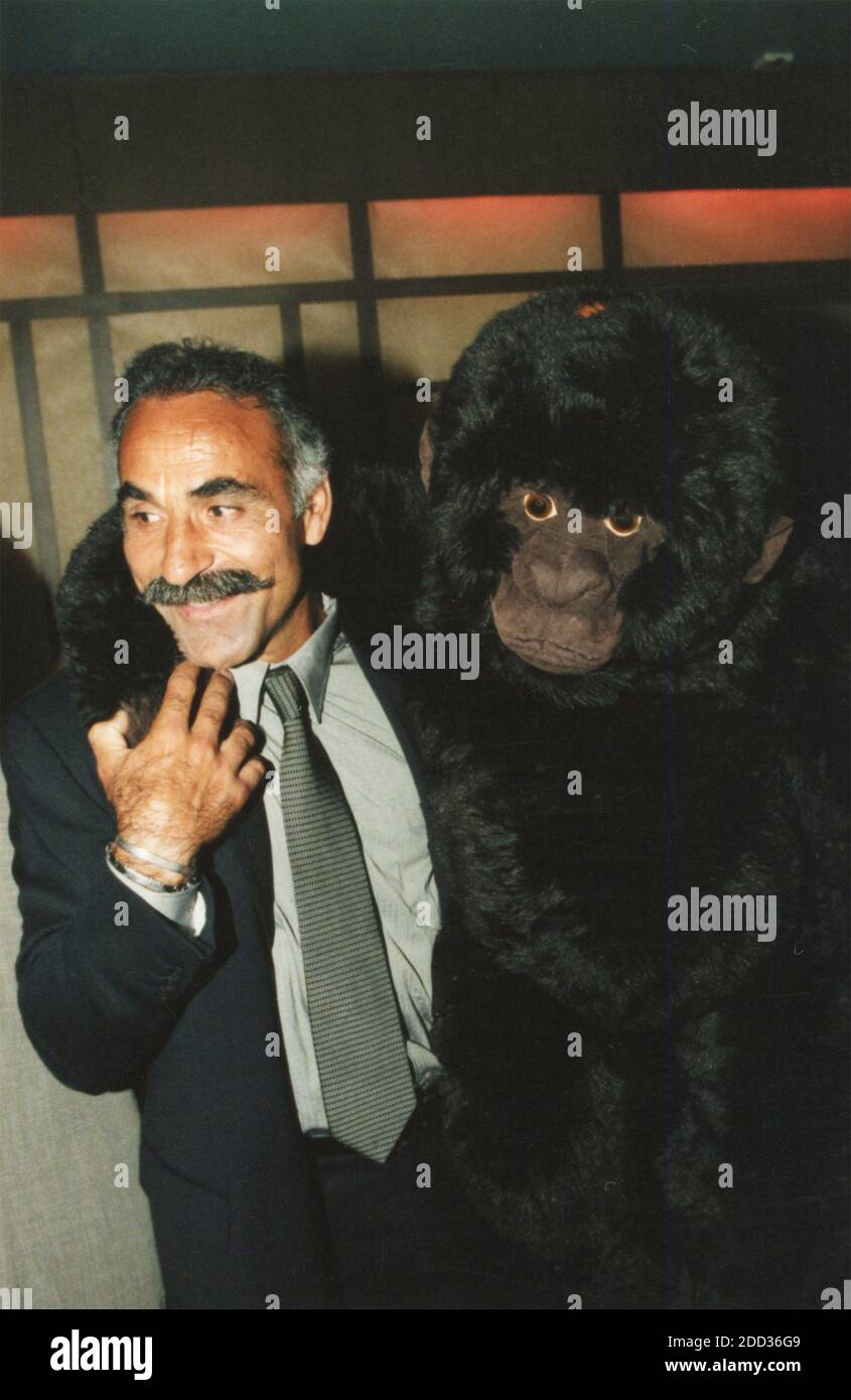 Unidentified man with moustache hugging a teddy bear ape, 2000s Stock ...
