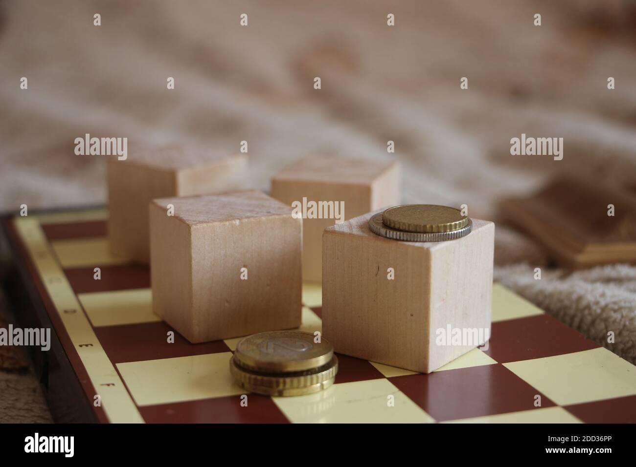 Money coins on chess board and wooden cubes, concept business ...