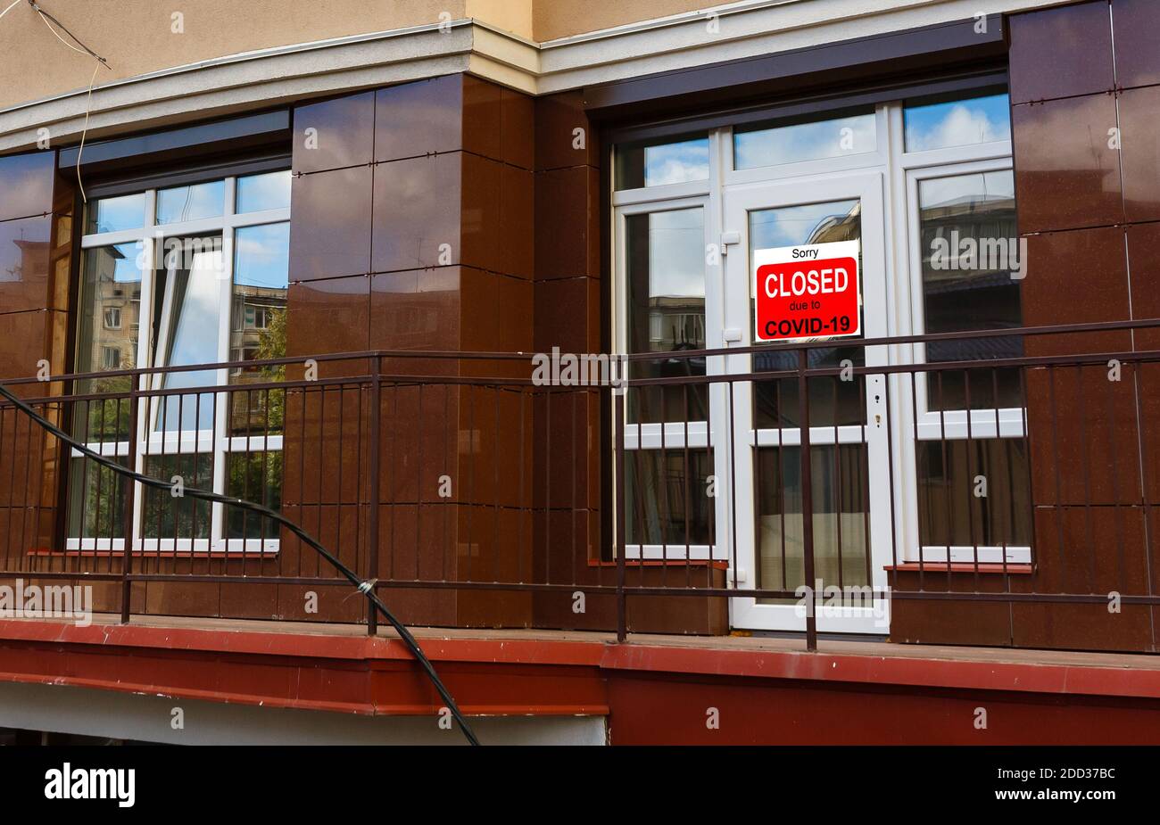 Business center closed due to COVID-19, sign with sorry in door window ...